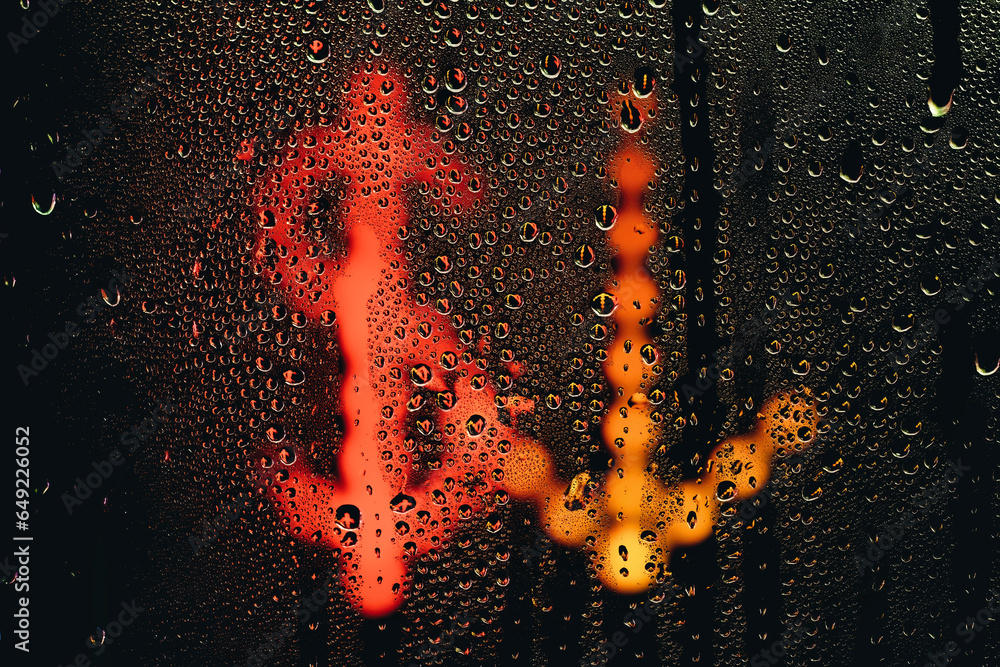 Blurred glowing dollar sign with arrow down made from light bulbs.The ...