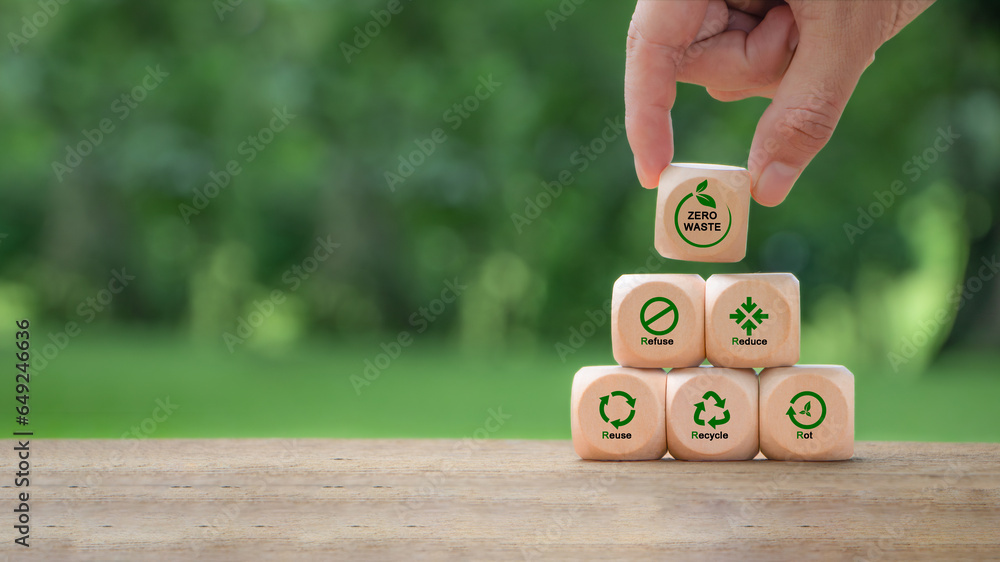 Hand arranging wood block with Zero waste icons and Reuse, Reduce ...