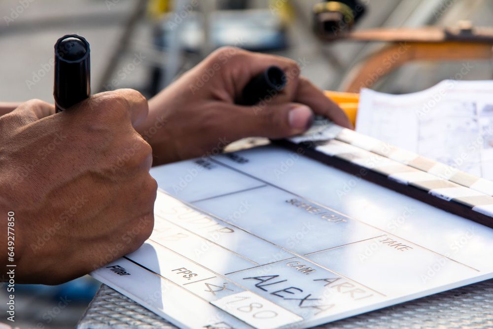 Labeling the Slate on set, film slate and film crew production set ...
