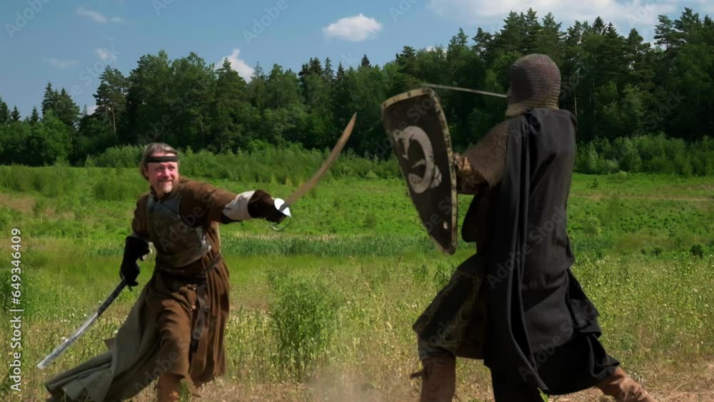 two warriors fight with swords, two knights fight with swords, two men ...