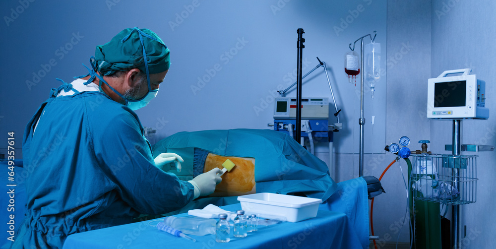 Surgical doctor cleaning with anti septic in back of patient preparing ...