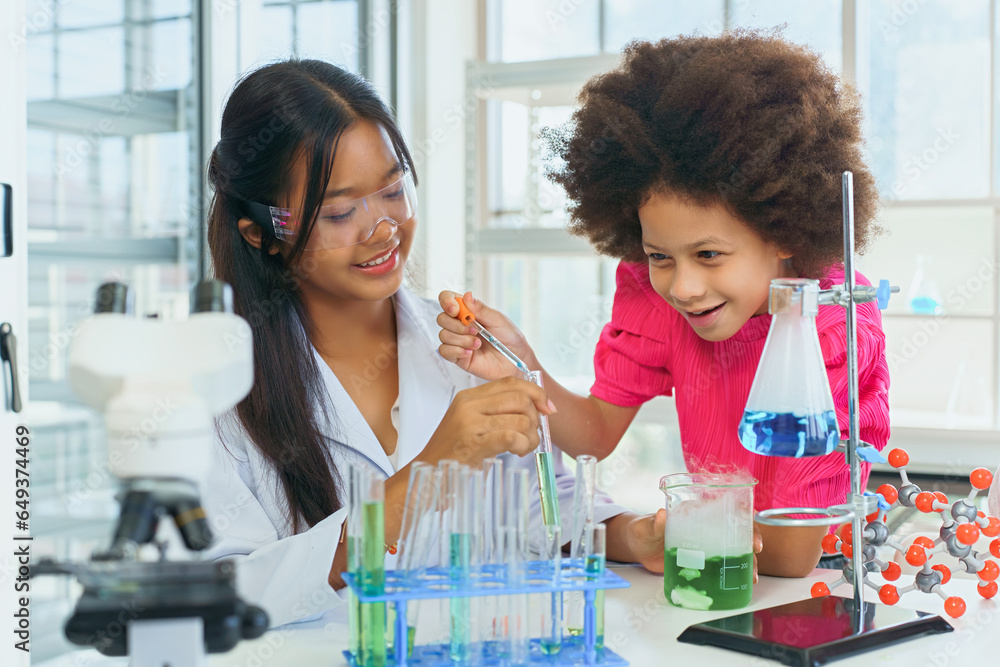 School children doing science experiments in school lab, children ...