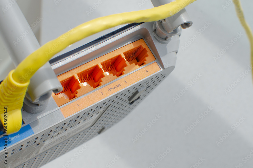 Close-up detail of a modern Wi-Fi router, with multiple inputs and ...