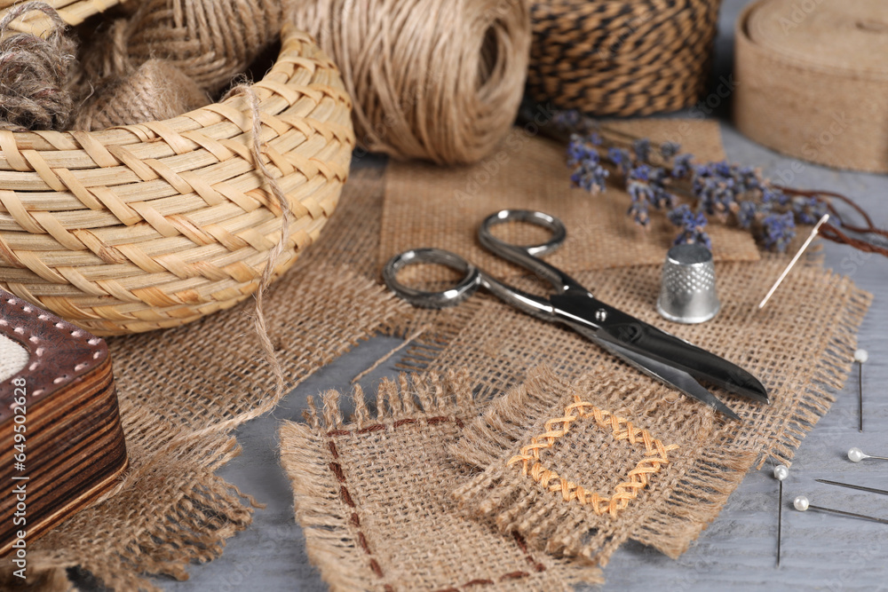 Pieces of burlap fabric with different stitches and sewing tools on ...