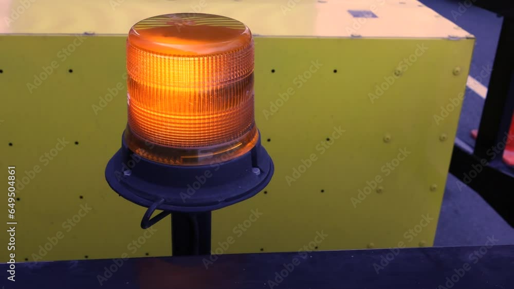 An amber warning light equipped with a rapidly rotating flasher ...