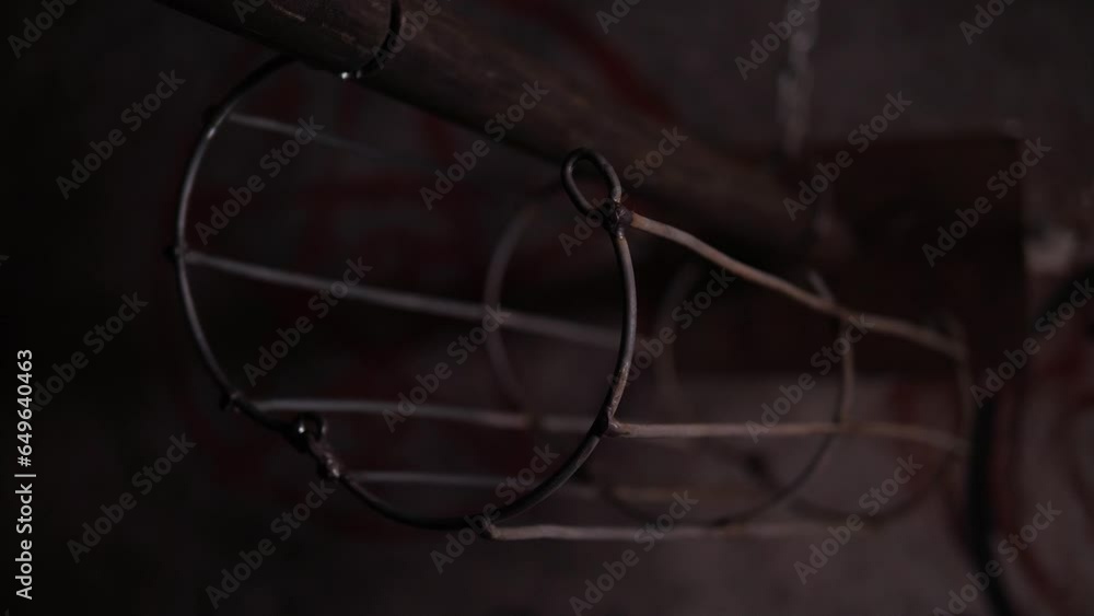 Close-up of an old pipe made of metal rods in a dark creepy room, a ...