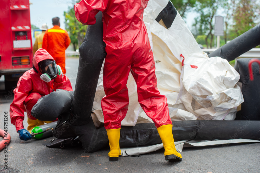 Rescuers wearing red hazmat suits assembled a Inflatable sterilization ...