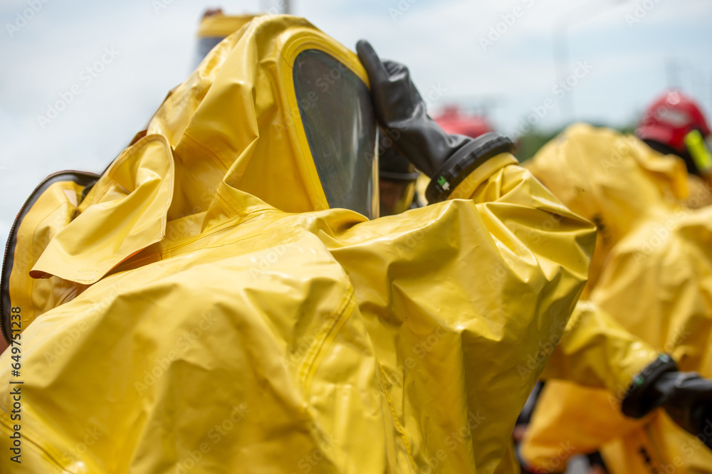 Rescue workers were wearing yellow hazmat suits with oxygen tanks ...