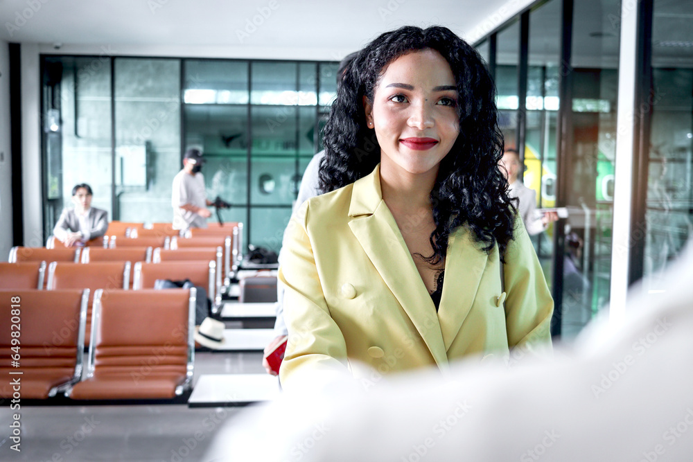 Beautiful female traveler gives passport boarding pass to passenger ...