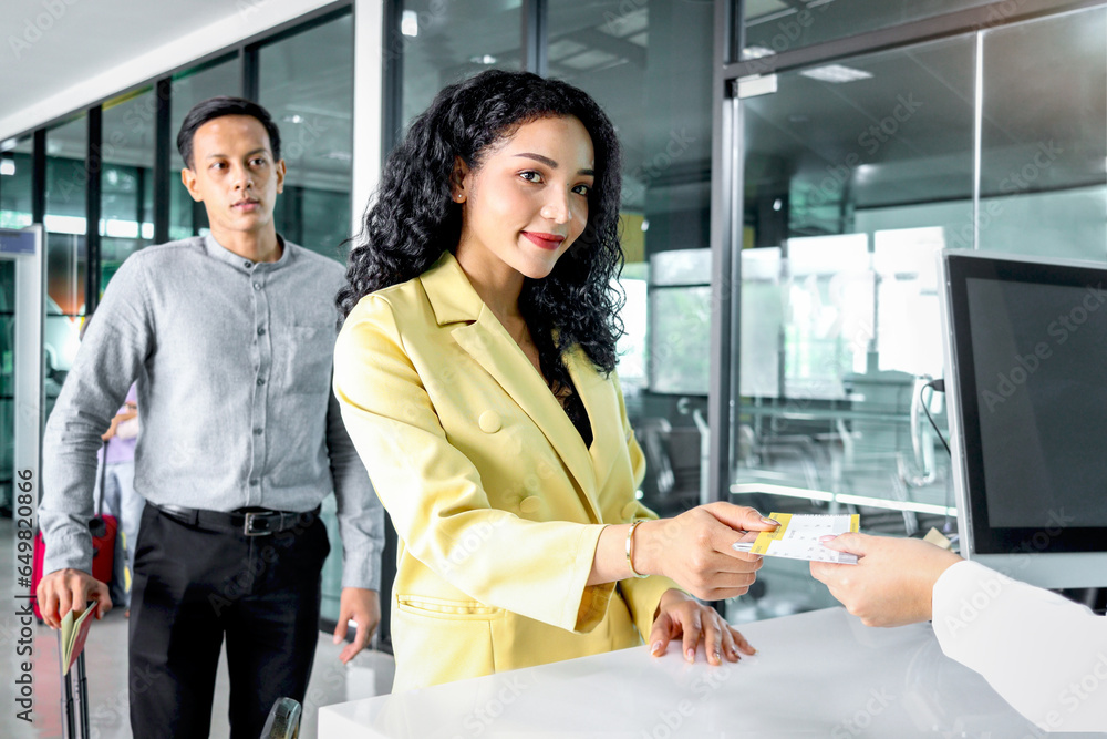 Beautiful female traveler gives passport boarding pass to passenger ...