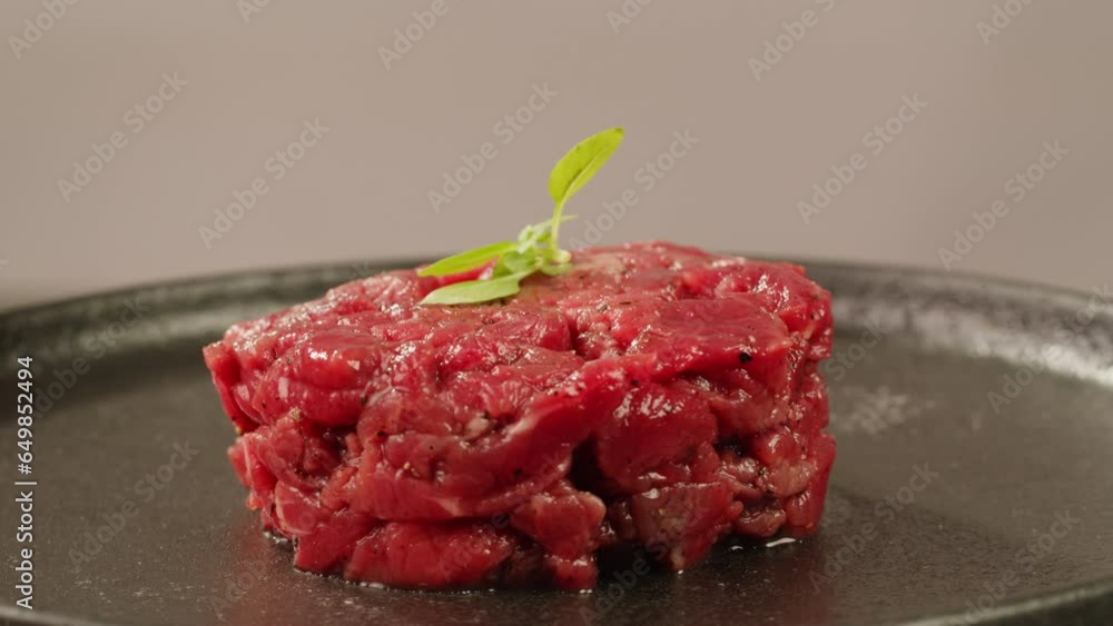 Chef cooking Raw beef meat tartar with sauce, man cutting steak tartare ...