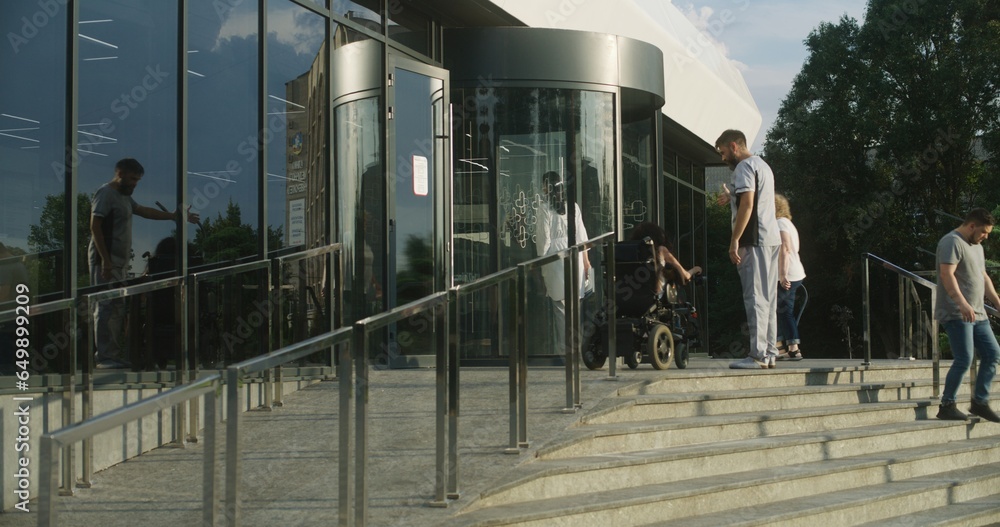 Woman with physical disability rides into clinic entrance on motorized ...