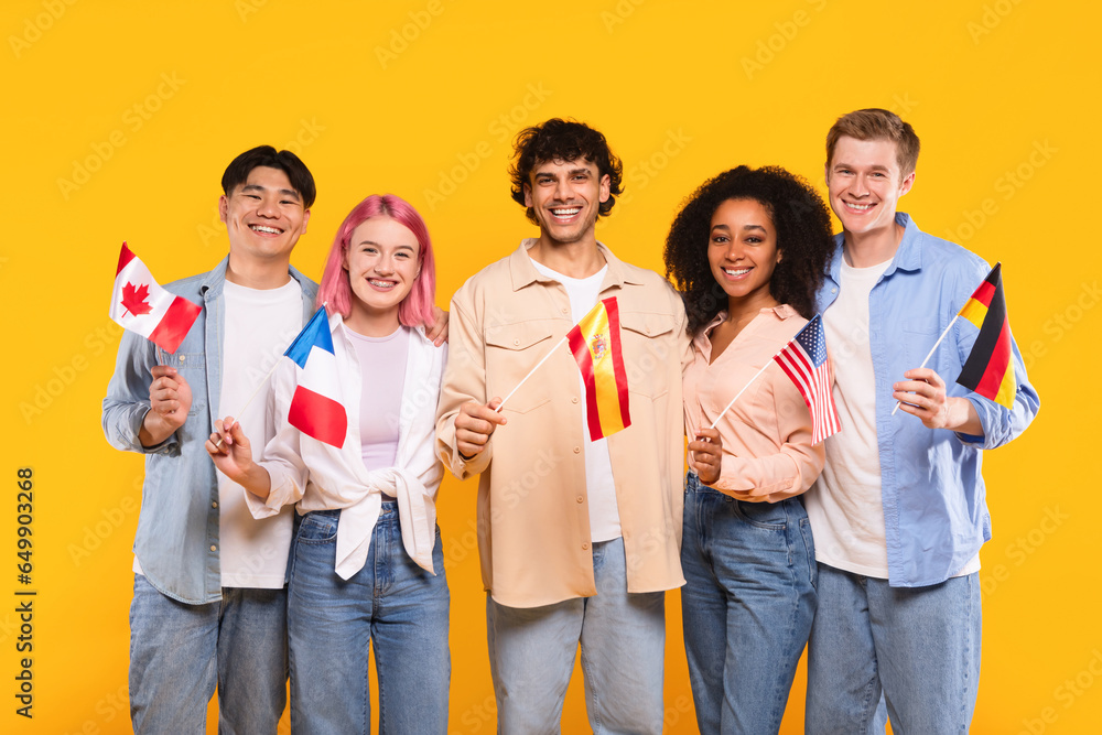 Happy multiracial people holding different countries flags and smiling ...