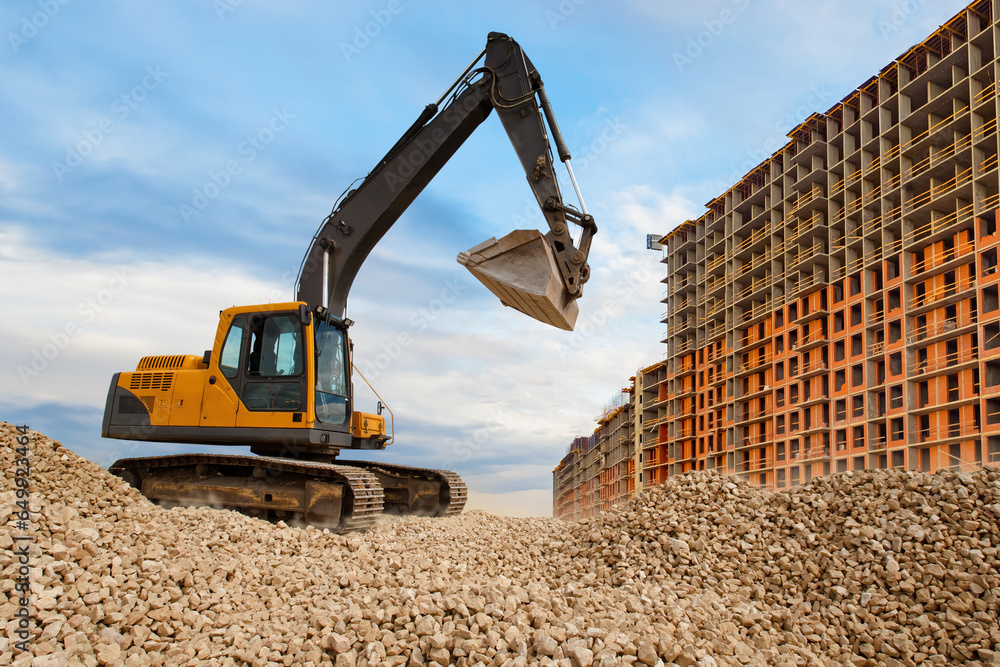 Excavator near house under construction. Process of building ...