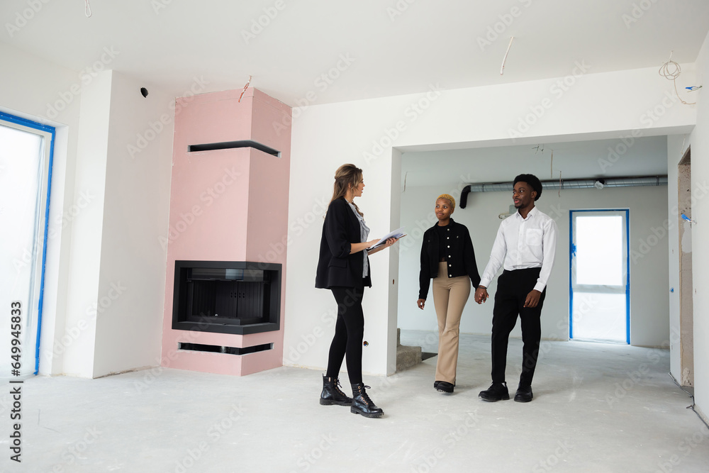 Well-informed blonde woman realtor is showcasing an inviting house to ...