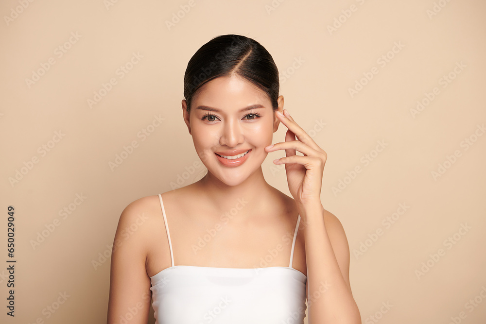 Beautiful young asian woman with clean fresh skin on beige background ...