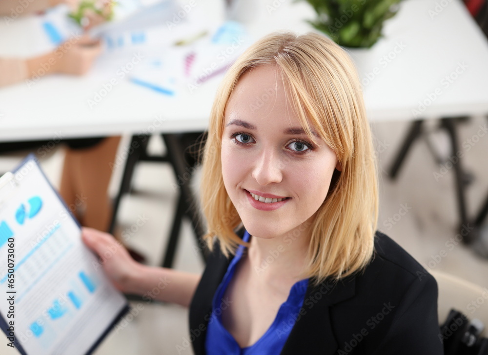 Beautiful smiling cheerful girl at workplace look in camera with ...