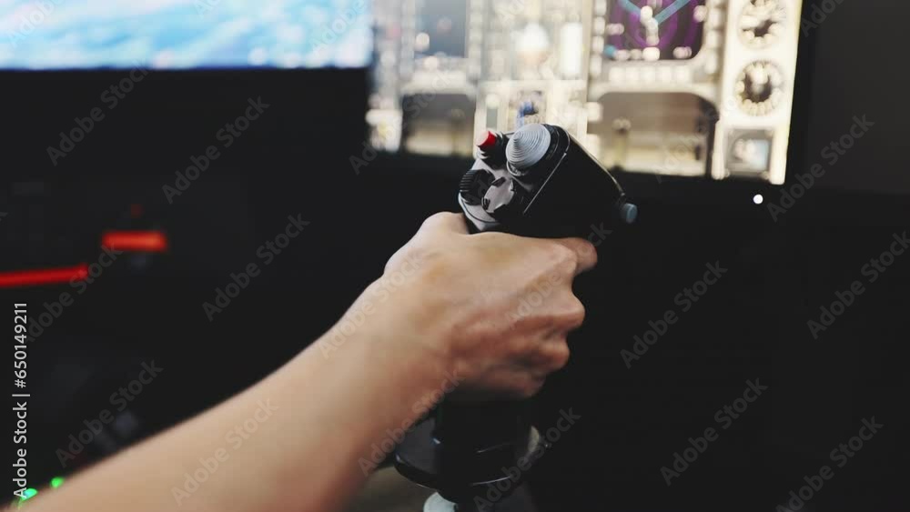 Close up of female hand holding gaming joystick in flight simulator and ...