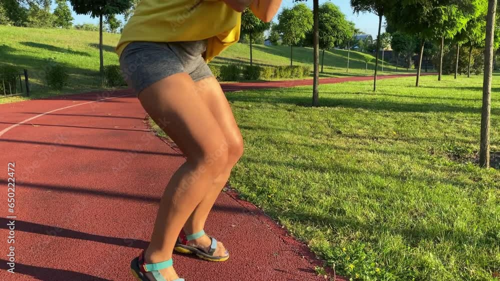 Young Woman Embarks On An Intense Leg And Thigh Workout During A Sunny young-woman-embarks-on-an-intense-leg-and-thigh-workout-during-a-sunny
