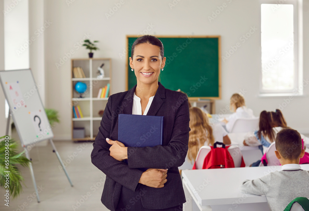 Portrait of happy beautiful female school teacher. Young woman in suit ...