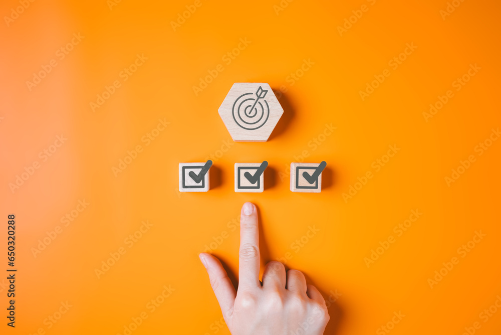 Hand with business target goal and check mark sign icons for increasing ...