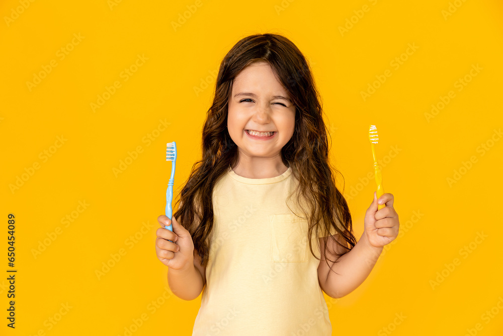Foto de Twice faster. Child girl holds two toothbrushes. Child ...