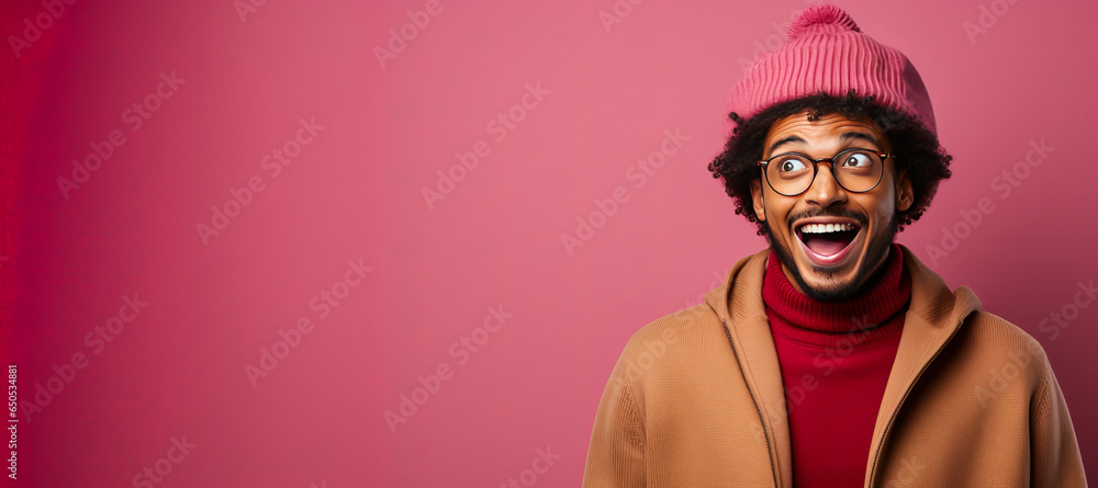 Charming young man in a sweater, blushing with shy look away on vibrant ...
