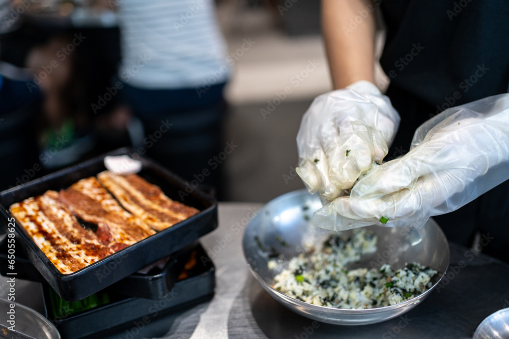 Hands making Korean seaweed rice ball called in Korean is Jumeogbab ...
