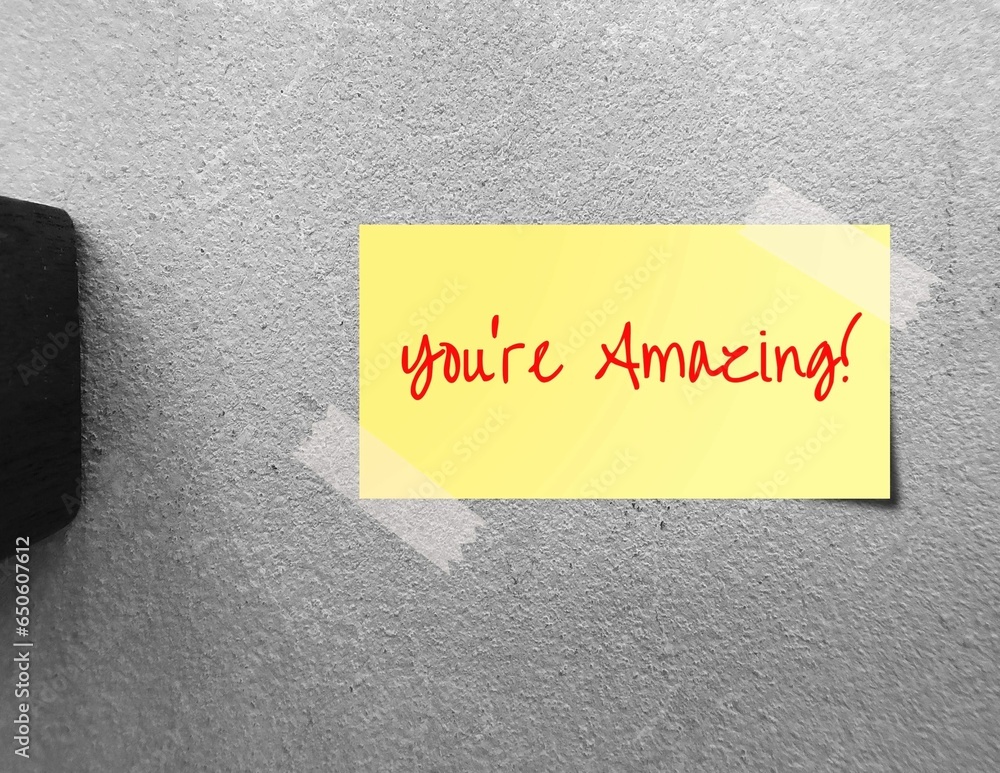 Yellow note stick on wall with handwritten text YOU'RE AMAZING, nice ...