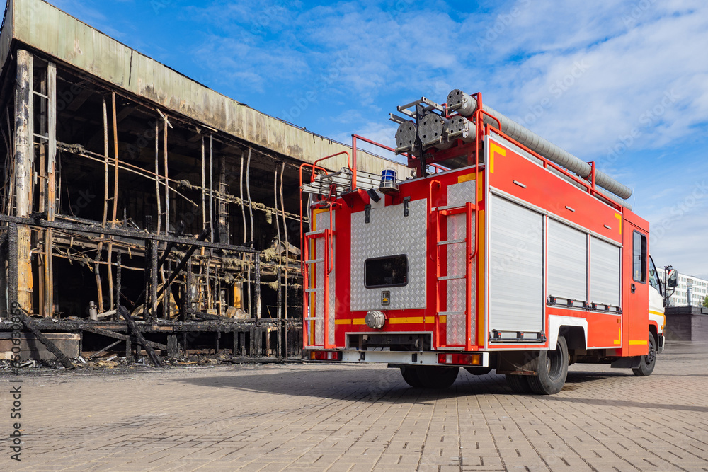 Rescue vehicle. Burnt out two-story house. Fire service truck. Rescue ...