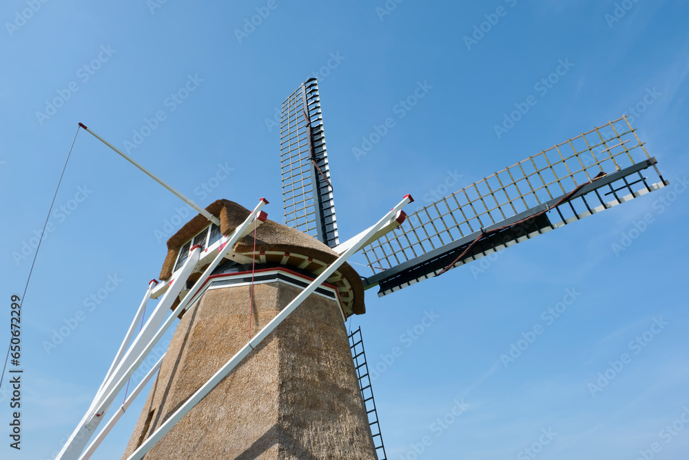 Closeup of the back of a traditional thatched dutch windmil in Hantum ...