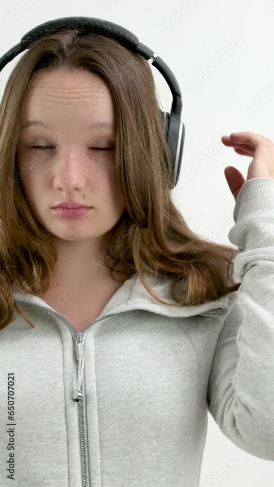 scratching eyes allergic reaction teenage girl wearing headphones ...