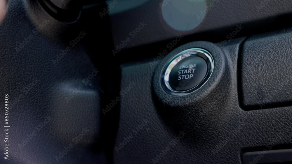 a modern and convenient keyless ignition system. woman's index finger ...