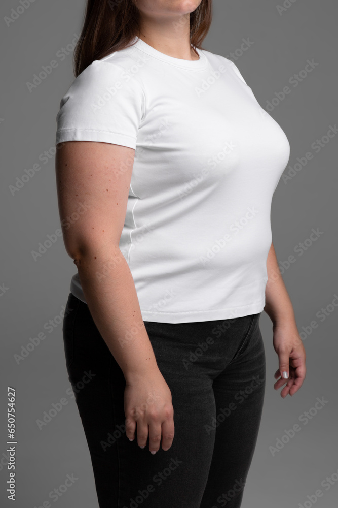 Plus size model on grey background with no face. Young female in blank ...