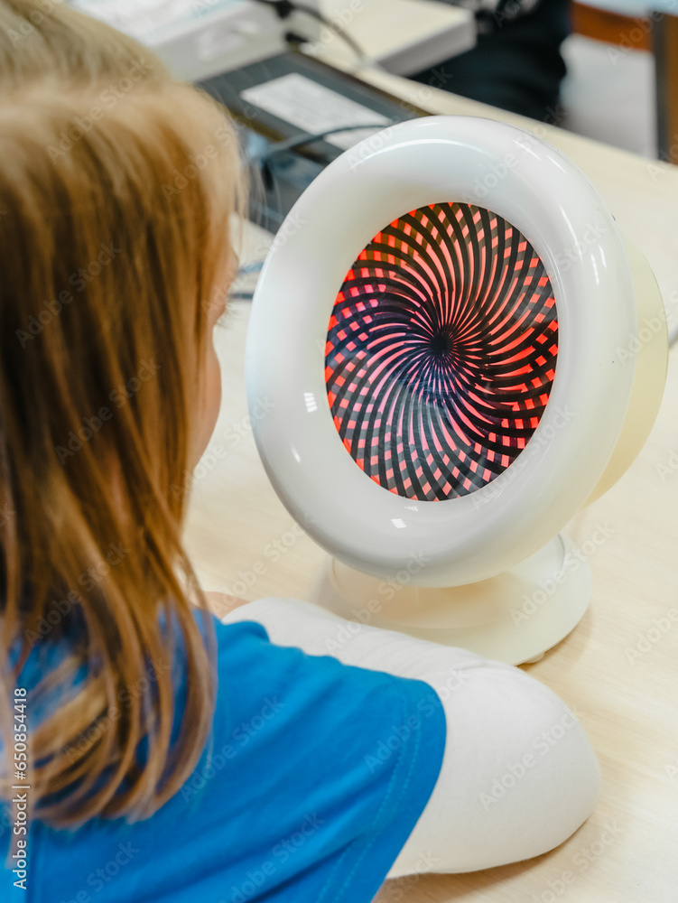 Little girl in medical office undergoing advanced laser vision ...