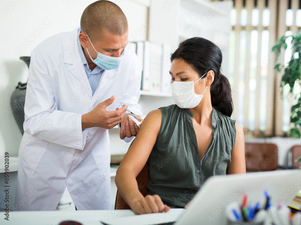 Asian female office employee in protective face mask getting antiviral ...