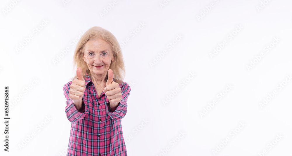 Positive healthy elderly woman showing thumbs up success looking at ...
