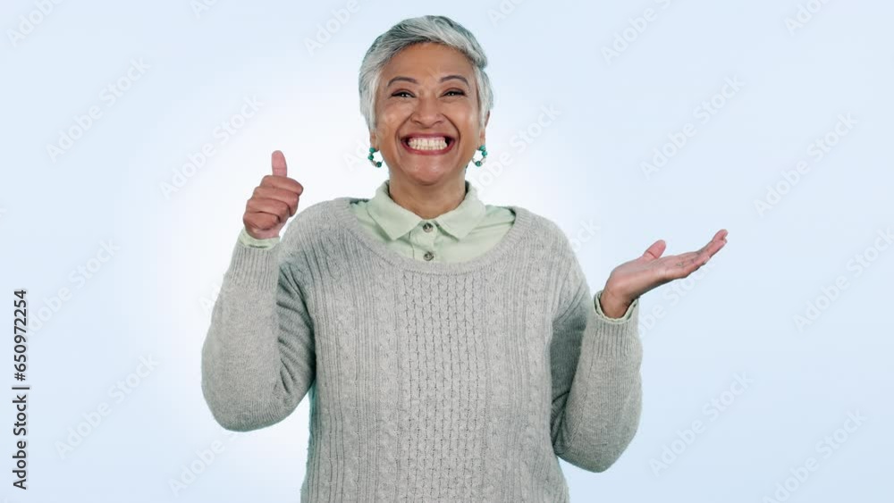 Face, mature woman and thumbs up for hand, pointing and support in ...