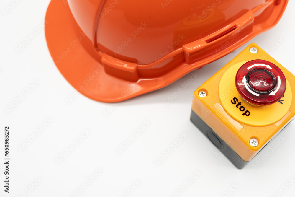 Orange safety hat with Emergency Stop Button isolated on white ...