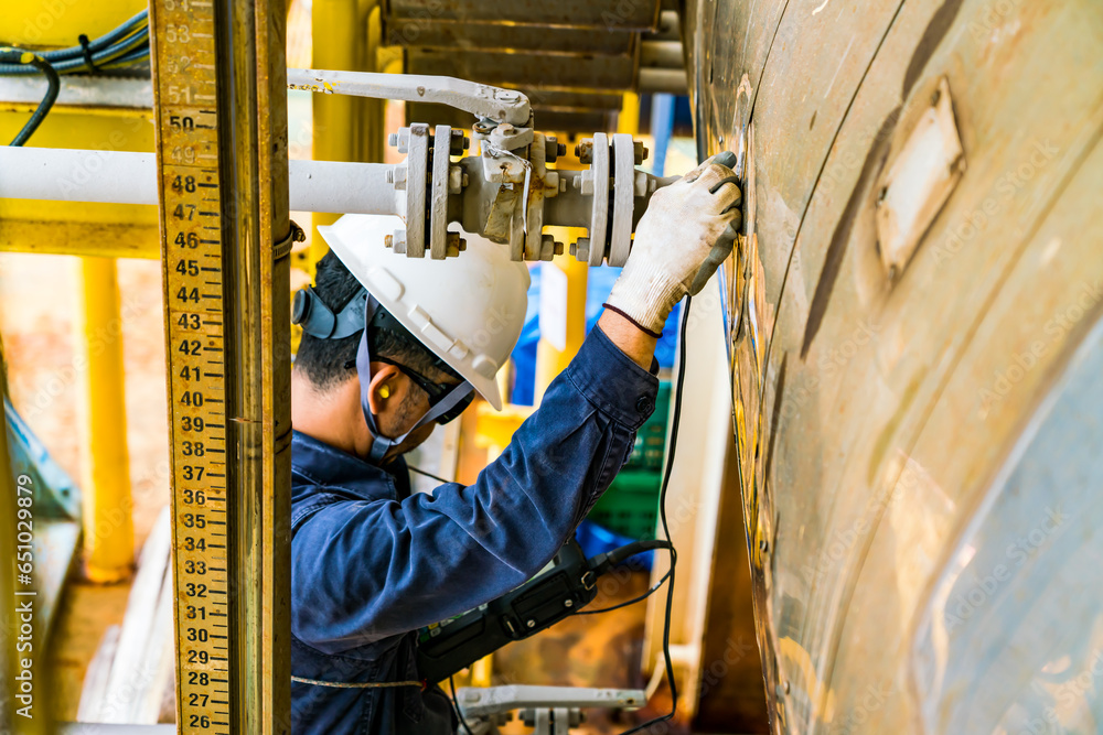 Non-destructive testing technicians are checking the thickness of elbow ...