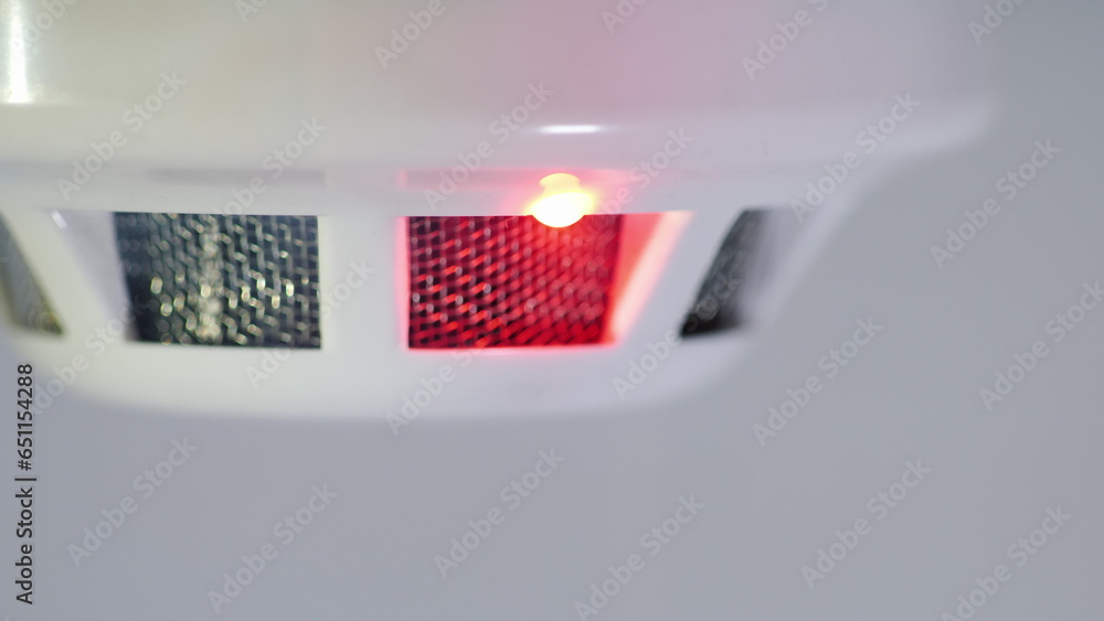 Close-up shot: The smoke detector is triggered by a trickle of dum, the ...