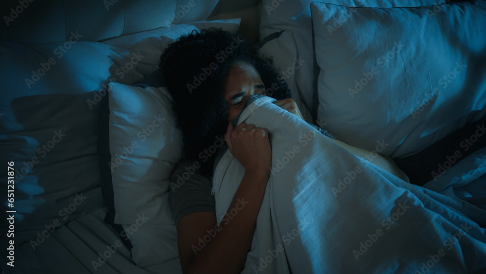 African american woman lying on bed night nightfall dark home bedroom ...