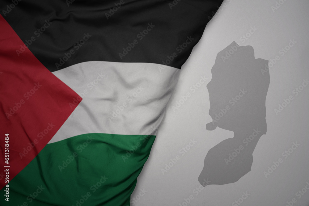 big waving national colorful flag and map of palestine on the gray ...