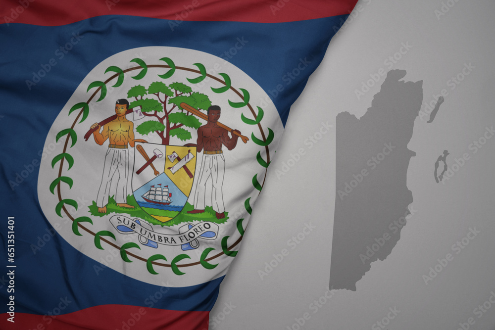 big waving national colorful flag and map of belize on the gray ...