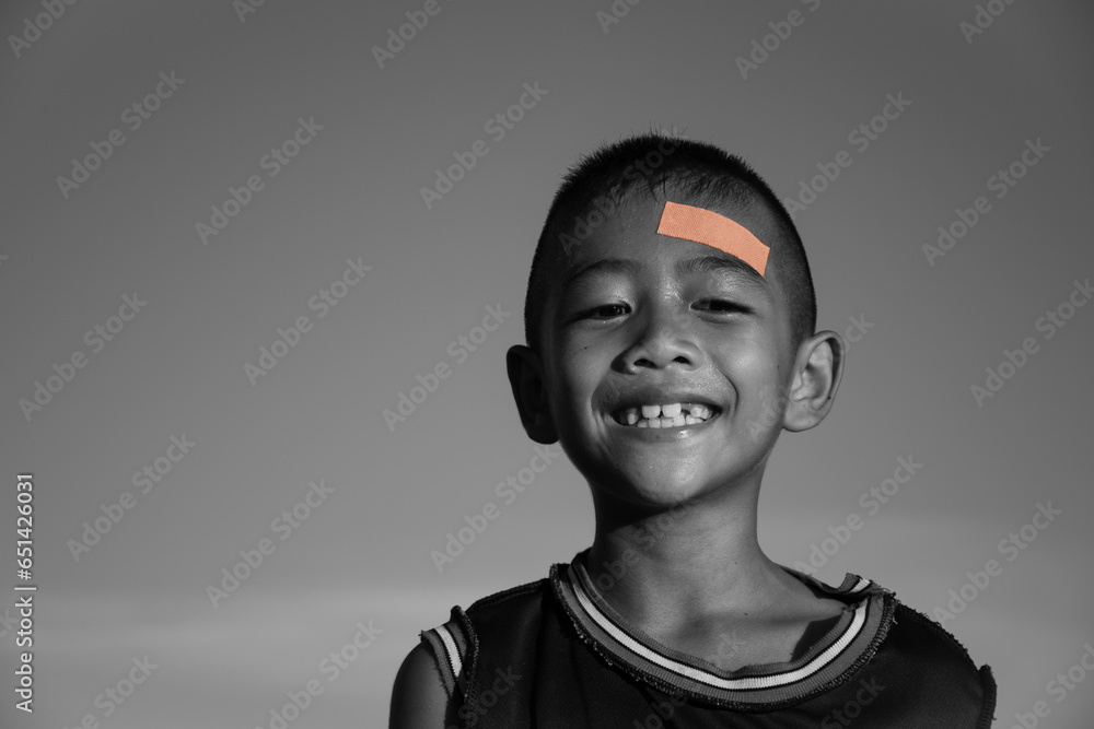 Happy boy smile and charming have plastic bandage on head wound ...