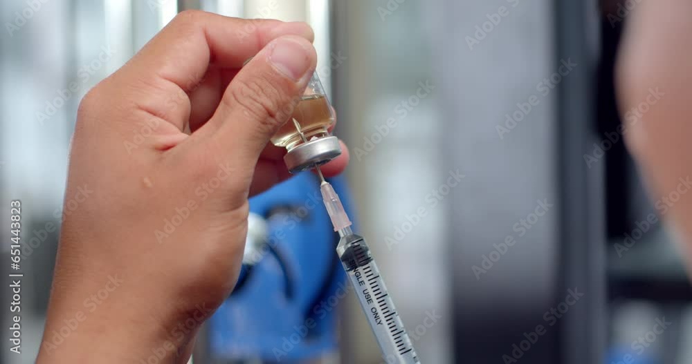 Using syringe suck out of bottle by turning the medicine bottle upside ...