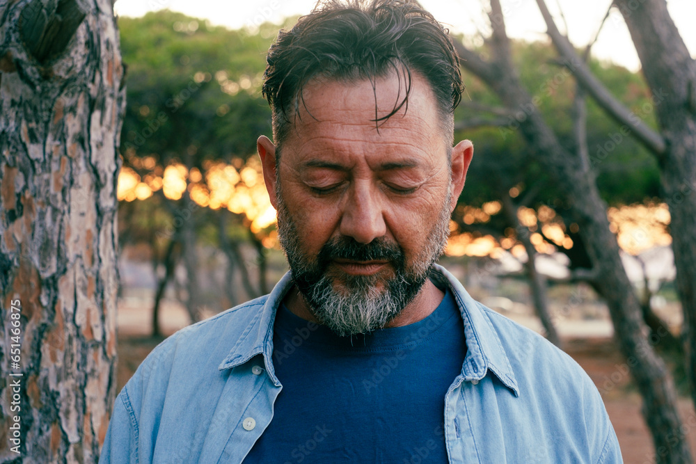 Sad man portrait expression face close up in outdoor park. One adult ...