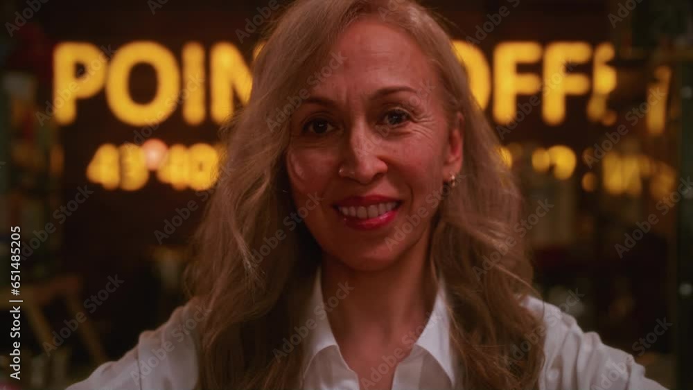 Portrait: a beautiful aged woman looks at the camera in a cafe. Senior ...