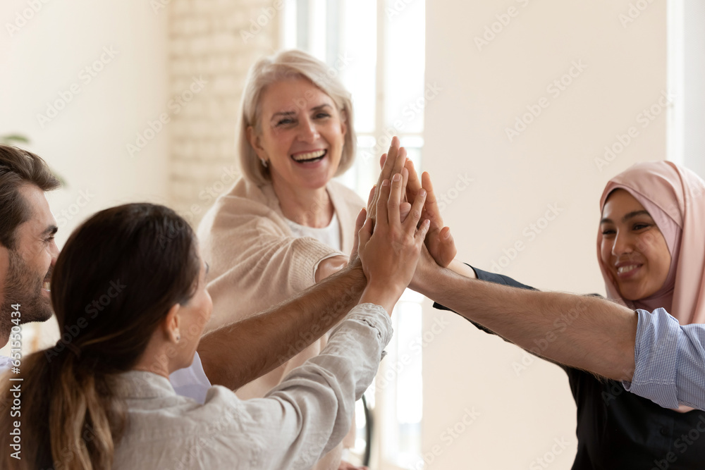 Motivated happy 50s and millennial affiliates celebrating sales growth ...