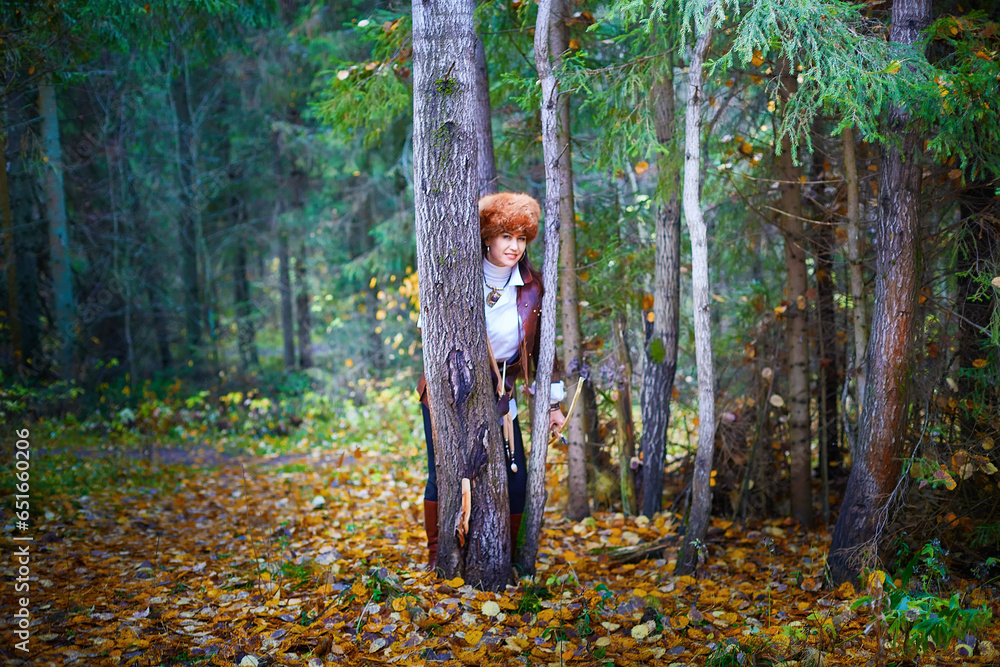Girl in a leather jacket, a big red fox fur hat and with a crossbow in ...